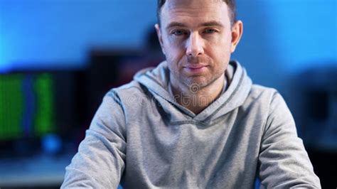 Portrait Of Confident Programmer Or Hacker Looking At Camera Typing On