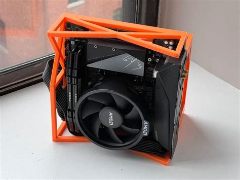 an orange and black computer case sitting on top of a white table next