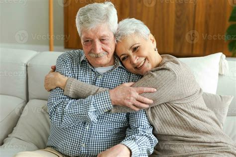 Senior Adult Mature Couple Hugging At Home Mid Age Old Husband And