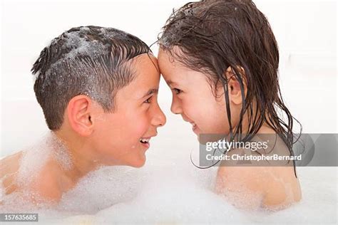 Brother And Sister Playing In Bath Tub Photos And Premium High Res