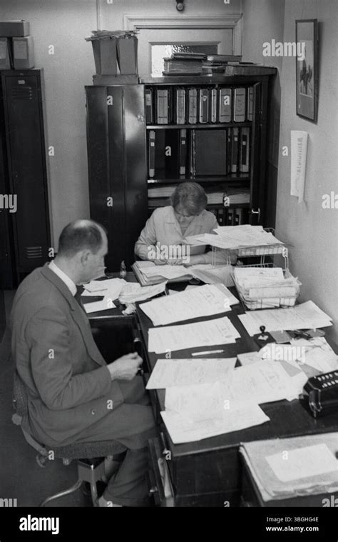 1950s Historical Male And Female Staff At Desks In Office England