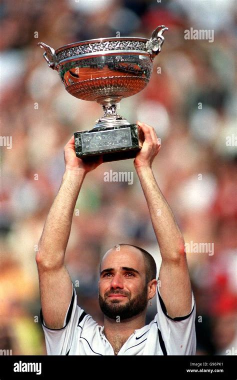 Andre Agassi Holds The Mens Singles Trophy Aloft After Beating Andrei Medvedev In Five Sets