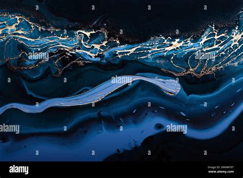 Fluid Art Liquid Metallic Gold In Abstract Blue Wave Marble Effect Background Or Texture Stock