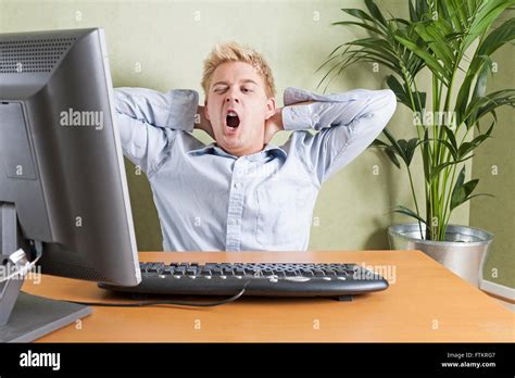 Tired Man Yawning When Working In Front Of Computer In Office Model