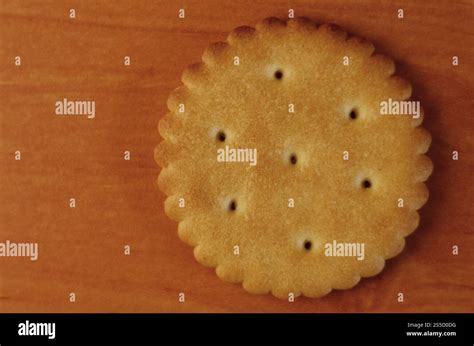 Background Image Of One Classic Salty Cracker On A Brown Wooden Table With Copyspace Classic