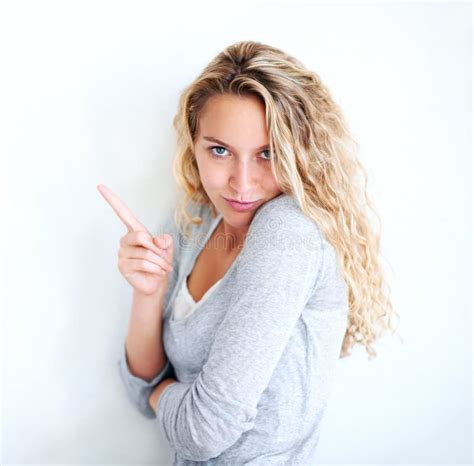 Naughty A Naughty Vivacious Blonde Looking At You And Pointing Away Stock Photo Image Of