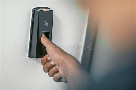 Man Pressing Fingerprint Scanner On Alarm System Indoorsfinger Print Scan For Unlock Door