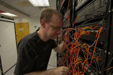 Premium Photo Engineer Configuring Vlans Virtual Local Area Networks On Network Switches