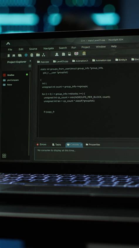 vertical focus on laptop used by engineers coding in modern data center