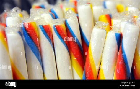 Background Image Shows A Bunch Of Candy Sticks That Are Striped Blue