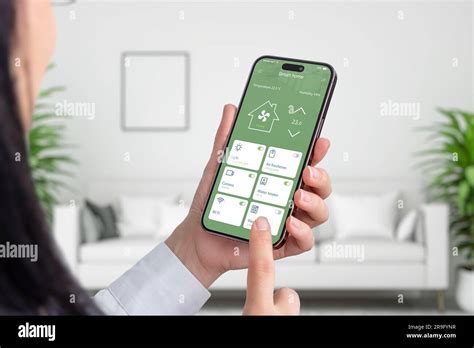 Woman Use Smart Home App On Smart Phone Living Room Interior In