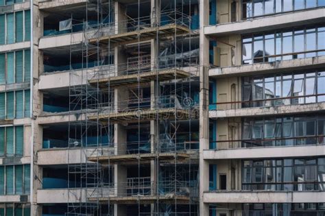 outdated scaffolding with broken and missing parts near modern building