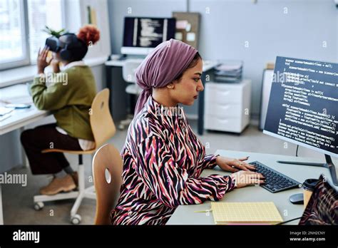 Side View Portrait Of Muslim Young Woman As Software Developer Writing