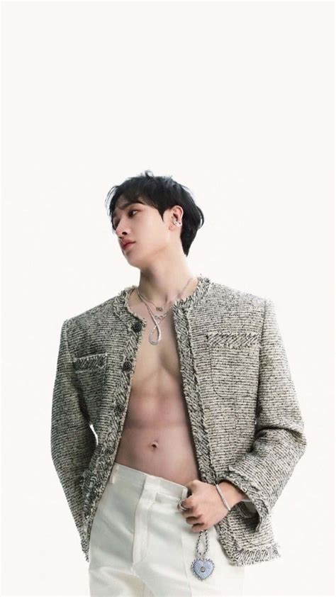 Download Stylish Male Modelin Tweed Jacketand White Pants Wallpaper