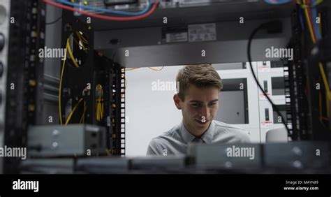 Technician Performing Maintenance Tasks In A Server Room Rack Stock Photo Alamy