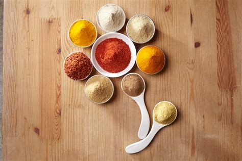 Premium Photo Close Up Of Various Spices In Containers On Table