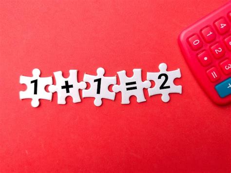 premium photo puzzles and calculator with number 1 plus 1 equal to 2