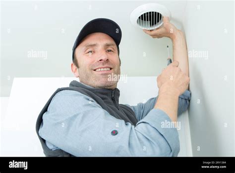 Portrait Of Man Fitting Ceiling Vent Stock Photo Alamy