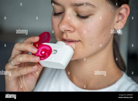 Close Up View Of Woman Using Medicine Dry Powder Inhaler For Treatment Asthma Or Copd Diseases