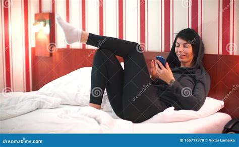 The Girl Sitting On The Bed Crossed Her Legs Stock Footage Video Of Indoors Happy 165717370