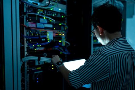 388 computer engineer is setting up network in server royalty free
