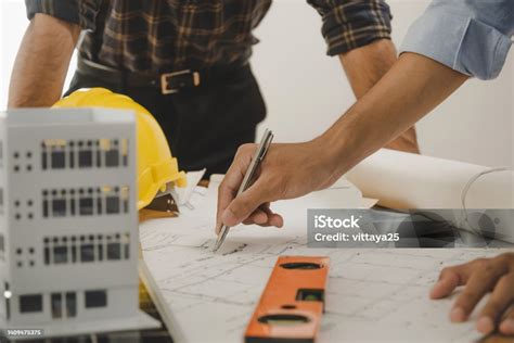 엔지니어 건축가 건설 노동자 팀 회의 청사진 및 건설 현장 계약자 건설 개념의 회의실 사무실의 작업장 책상에서 건물 모델에 대한 그룹 2명에 대한 스톡 사진 및 기타 이미지