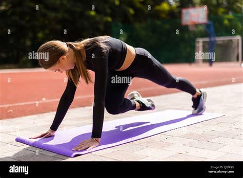 Fitness Girl Doing Abs Exercise To Tone Stomach Muscles Tiger Curl Reverse Crunch Planking