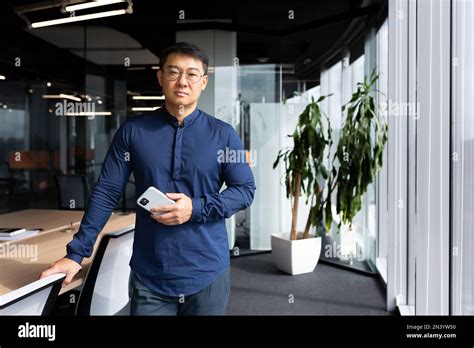 Portrait Of Serious Thinking Asian Man Inside Office Man In Glasses