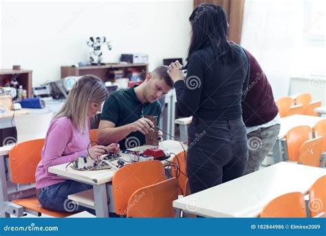 Scientists Engineers Designing Small Human Robot Setting Artificial Intelligence Humanoid Robot