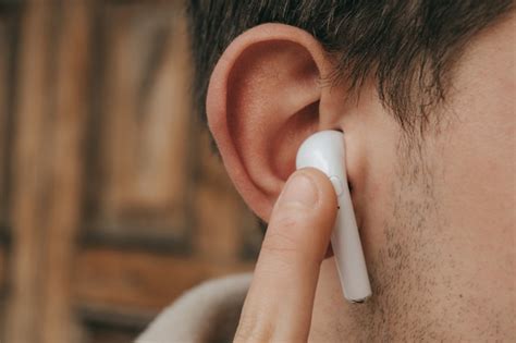 Premium Photo Man Changing The Volume Of His Wireless Headset