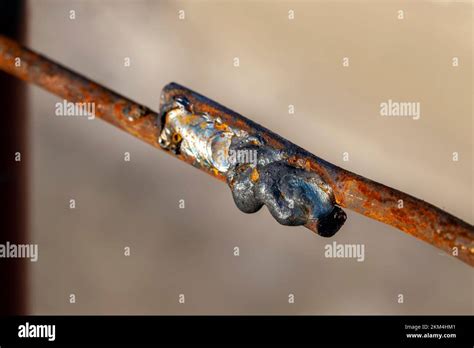 Welded Together Metal Fastening Parts Part Of A Rustic Fence Made Of