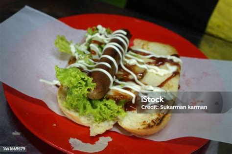 인도네시아 현지 핫도그 로스트 비프 소시지 참깨 빵 양상추 마요네즈 및 소스 핫도그 만들기 과정 길거리 음식 건강하지 못한 생활방식에 대한 스톡 사진 및 기타 이미지