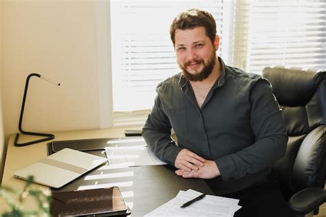 Premium Photo Portrait Of Man Working At Desk In Office