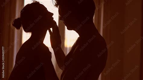 Silhouette Two Toung Lovers Touching Ambracing And Kissing Each Other Soft And Tenderly Against