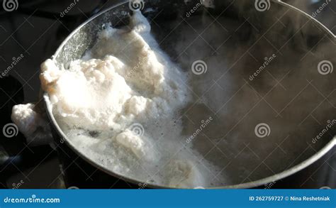 Pot Boiling Over With Chicken Bouillon Bursting Spilling Out On Gas Stove Boiling Pot