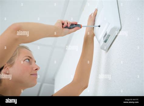 Woman Screwing With Screw Driver Thermostat Stock Photo Alamy
