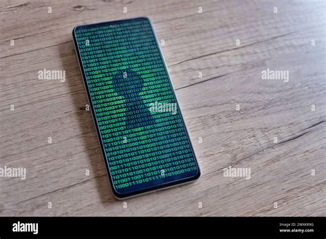 smartphone with glowing binary code and keyhole on the screen copy