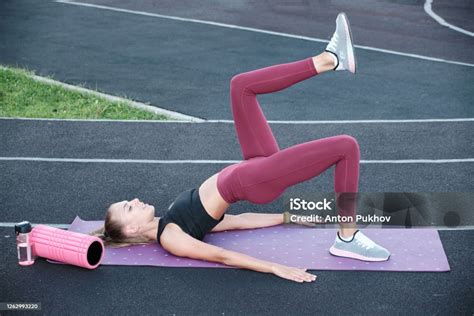 Sport Fitness Girl Doing Exercises On The Buttocks On The Yoga Mat At