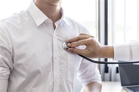 A Doctor Is Using A Stethoscope To Listen To The Lungs Of A Patient Who