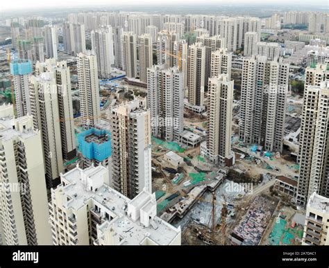 Aerial View Of Massive Building Sites In Construction With Tower Crane