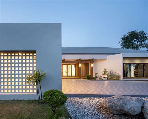 Wooden Folding Blinds Invite Greenery Within Residence In Thailand
