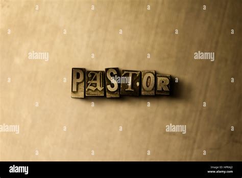 Pastor Close Up Of Grungy Vintage Typeset Word On Metal Backdrop