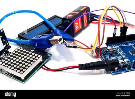 Microprocessor Board With Connected Power On A White Background Microprocessor Board With Connected Power On A White Background