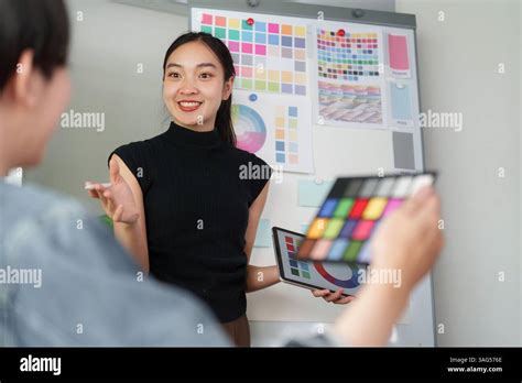 Creative Collaboration And Teamwork Ux Ui Designer Presenting Color Palettes To Her Team During