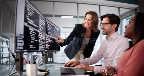 diverse coding team collaborating on software development stock image
