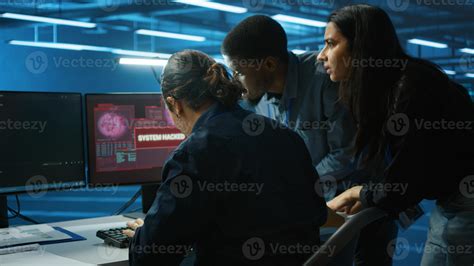 Multiethnic Programmer Team In Server Farm Workspace Surprised By Data
