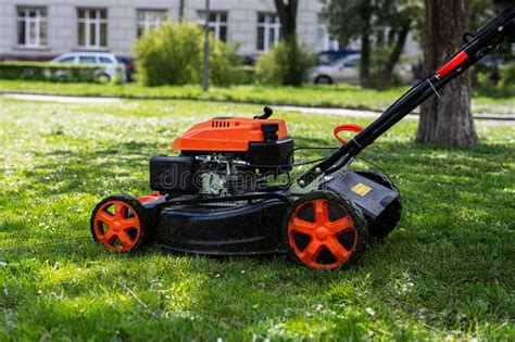 Communal Services Gardener Worker Man Using Lawn Mower For Grass