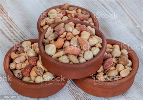 오래 된 소박한 테이블에 견과류와 말린 과일을 섞어 줍니다 골드 피스타치오 캐슈 헤이즐넛 아몬드 및 차 음식 배경입니다 0명에 대한 스톡 사진 및 기타 이미지 Istock