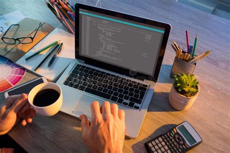 Hands Of Caucasian Male Programmer Sitting At Desk With Coffee Using Laptop With Coding On