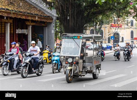 Commercial Tuk Tuk Travelling Through The Old Quarter Of Hanoi